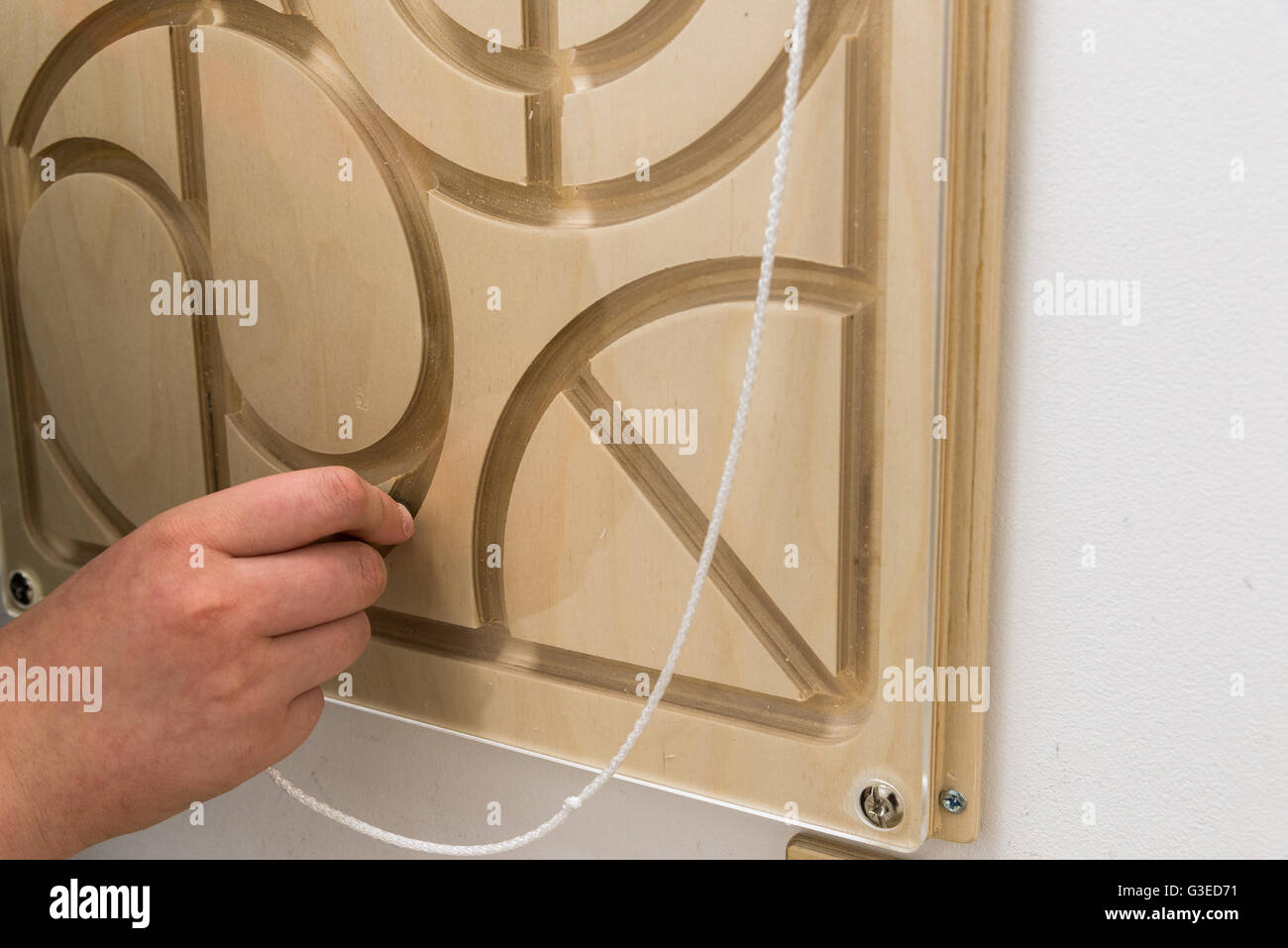 child playing of educational games hanging on wall Stock Photo - Alamy