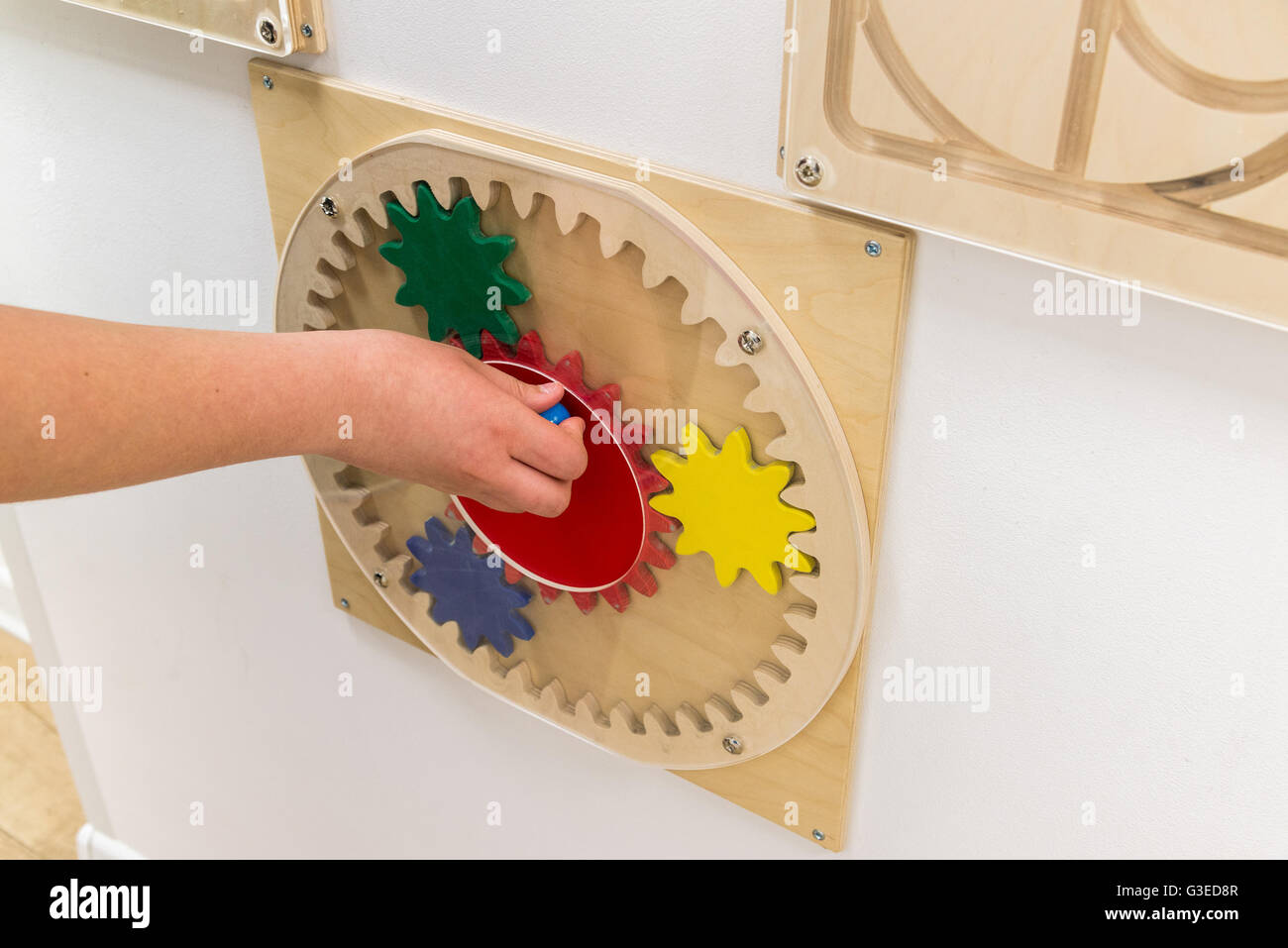 child playing of educational games hanging on wall Stock Photo - Alamy