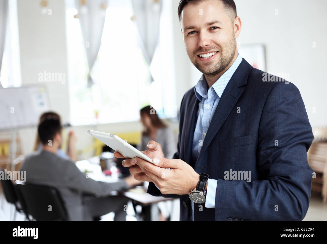 Handsome smiling confident businessman portrait Stock Photo - Alamy