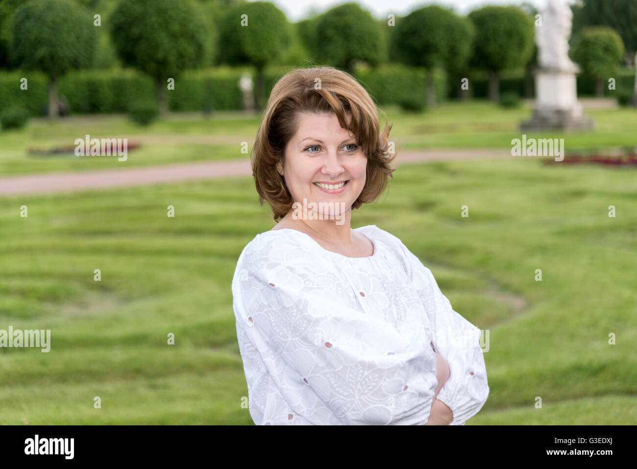 Portrait of a positive woman in a white blouse Stock Photo - Alamy
