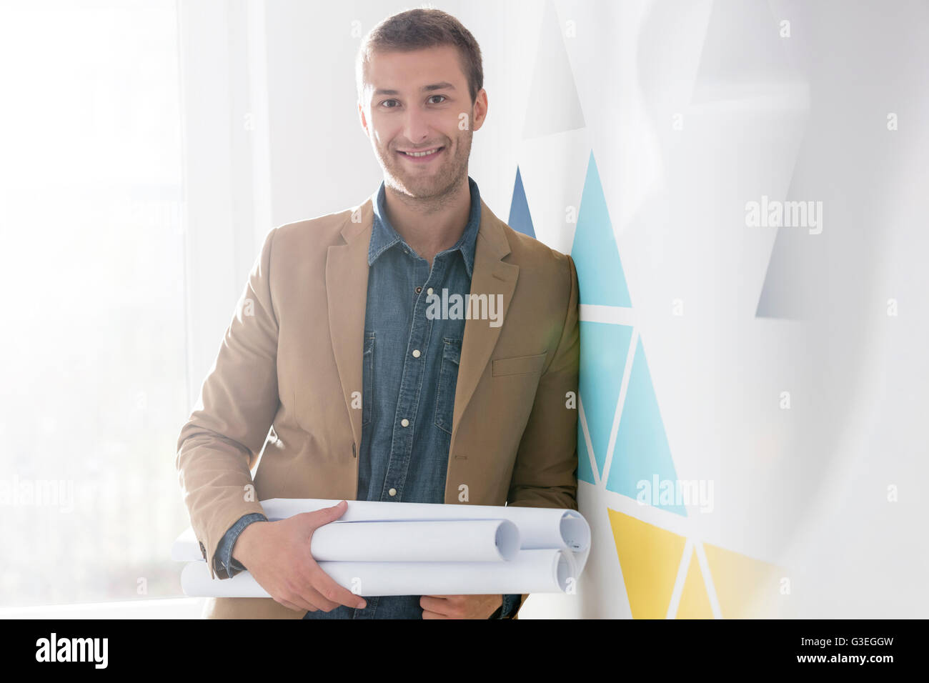 Portrait confident architect holding blueprints Stock Photo - Alamy