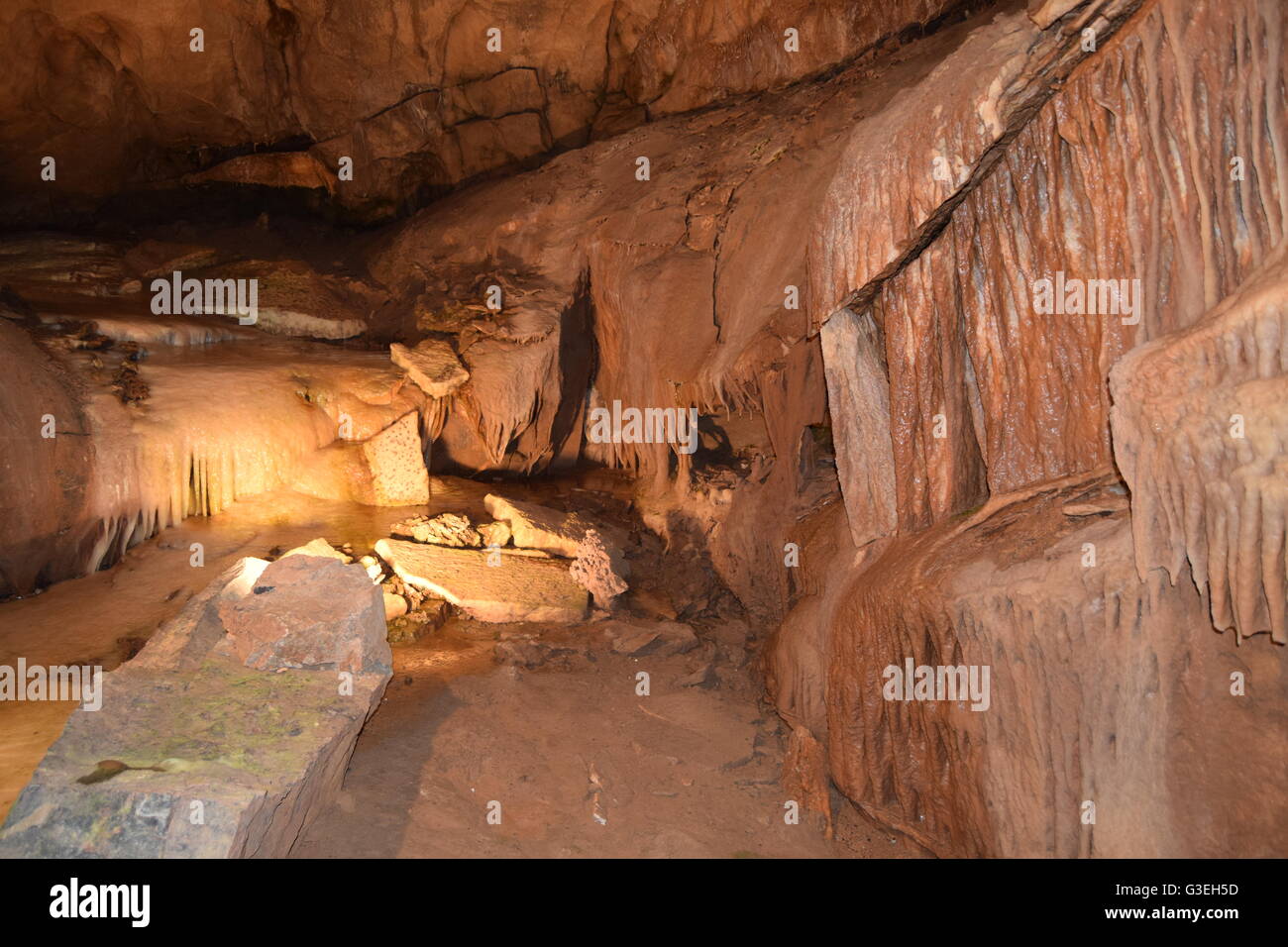 Stalactites formed down the wall by water in the limestone caves of ...