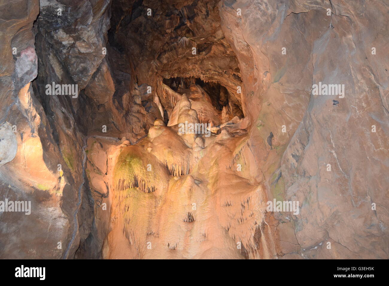 Stalactites formed down the wall by water in the limestone caves of ...