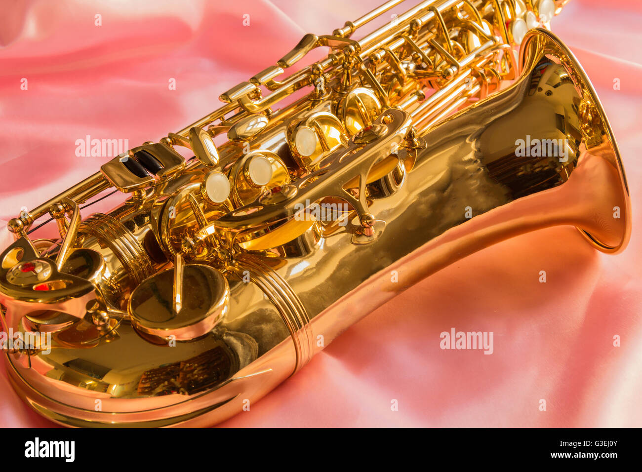 golden saxophone on delicate Pink silk Stock Photo - Alamy