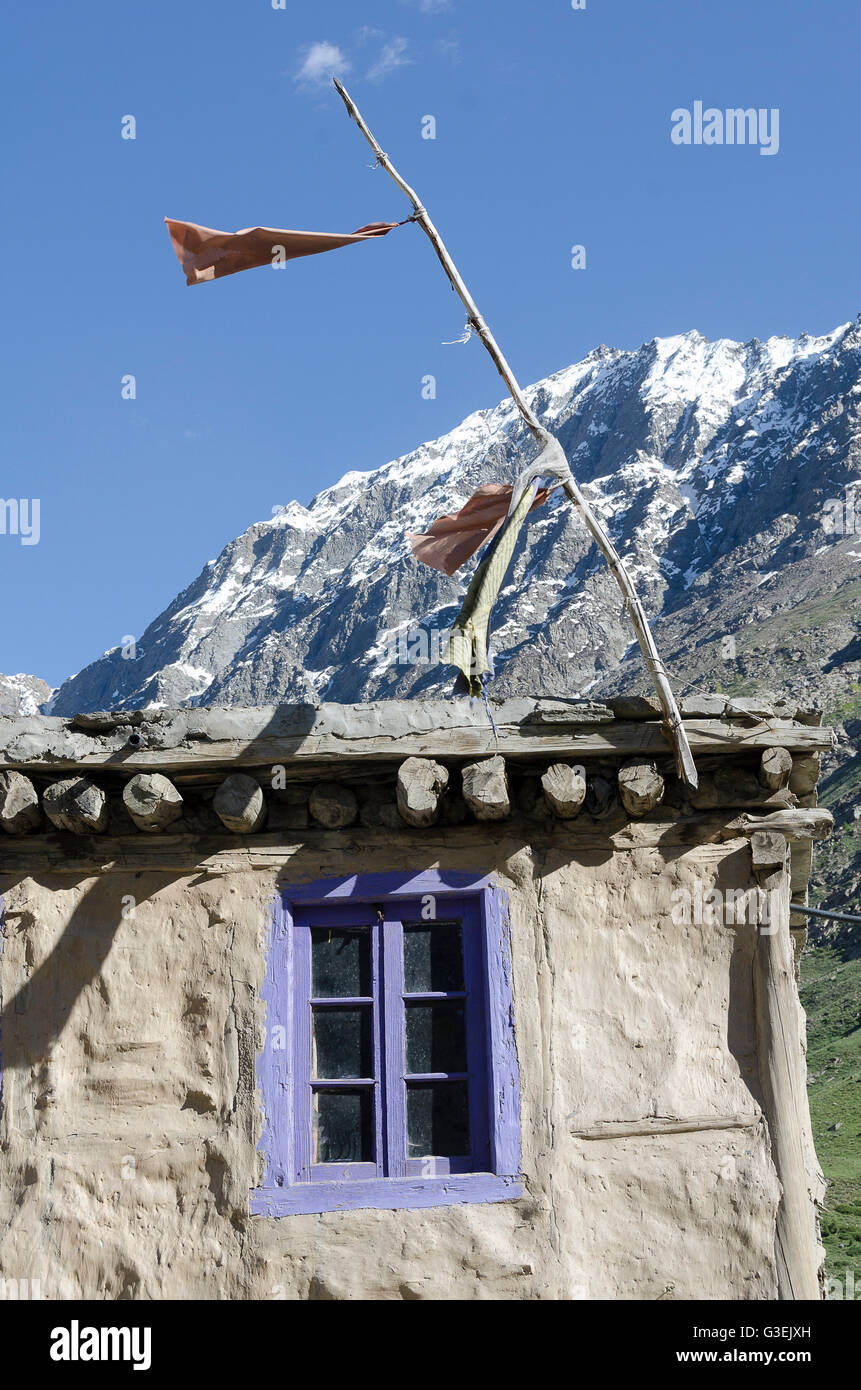 House with blue window and prayer flags, Jispa, Manali - Leh Road ...