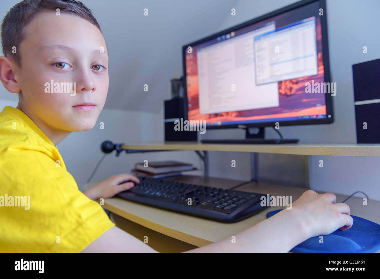 Boy working on computer in his room Stock Photo - Alamy