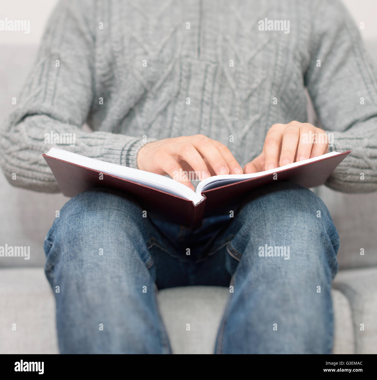 Blind man reading braille book on the couch Stock Photo - Alamy