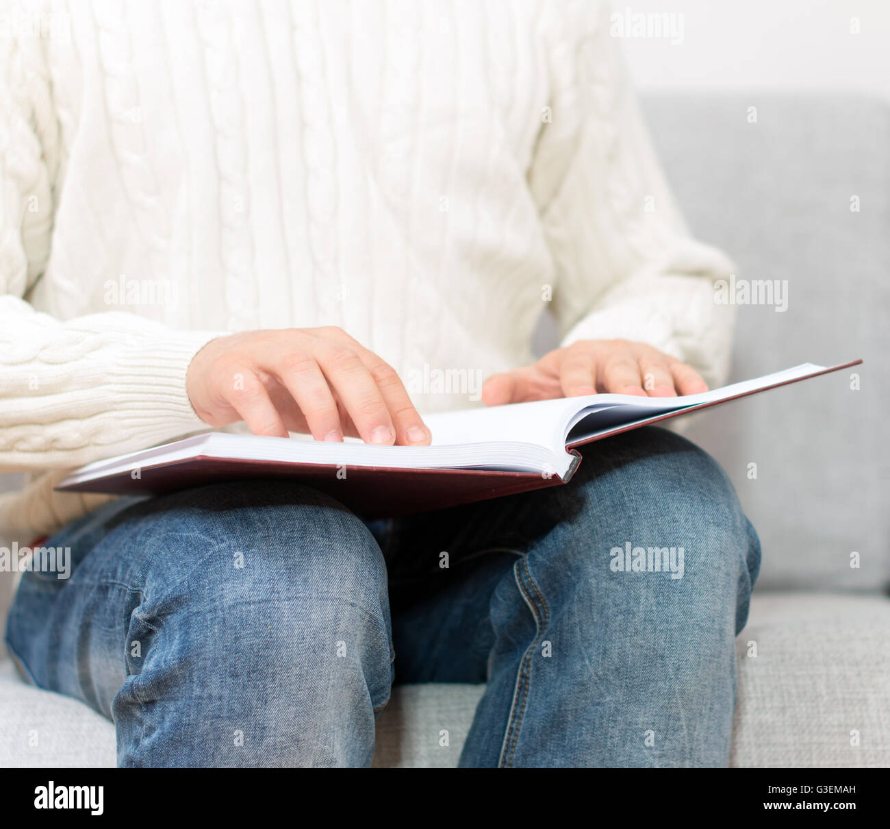 Blind man reading braille book on the couch Stock Photo - Alamy