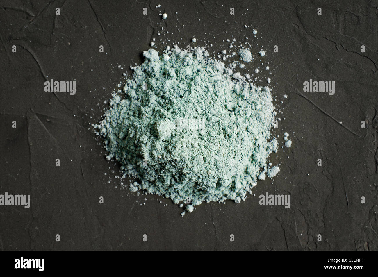 Blue cosmetic clay on dark background Stock Photo - Alamy