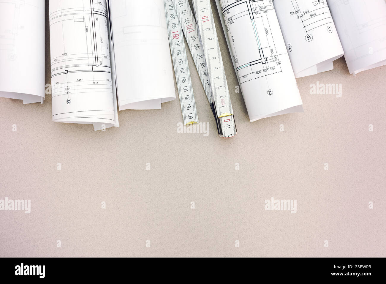 rolls of architecture blueprints and house plans with folding rule on ...