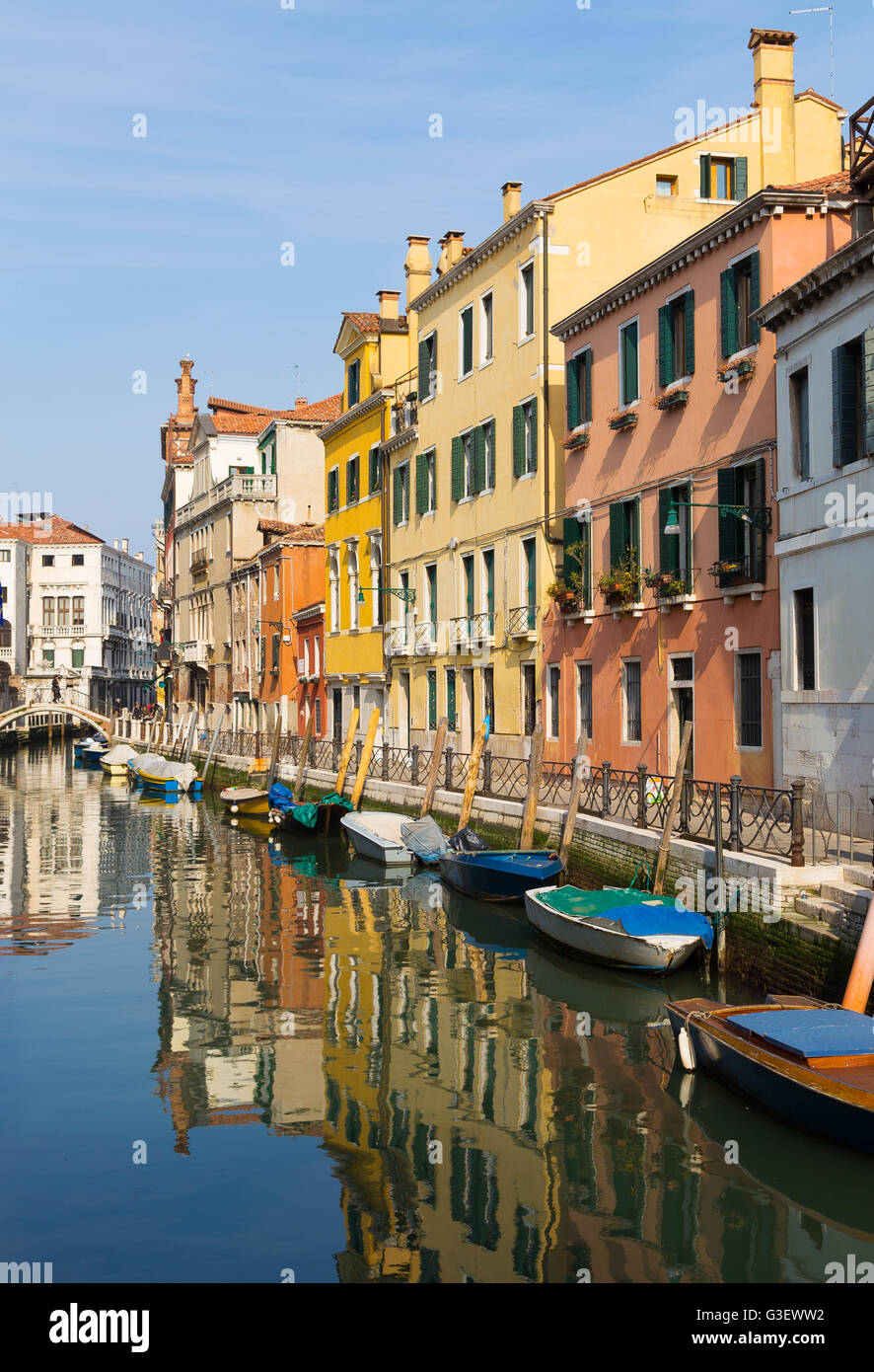 Colourful buildings in Venice during the day. Reflections can be seen ...
