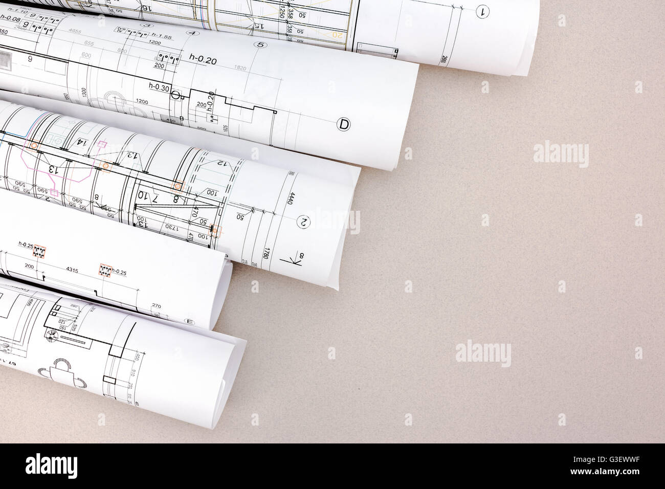 rolls of architecture blueprints and house plans on the desk Stock ...