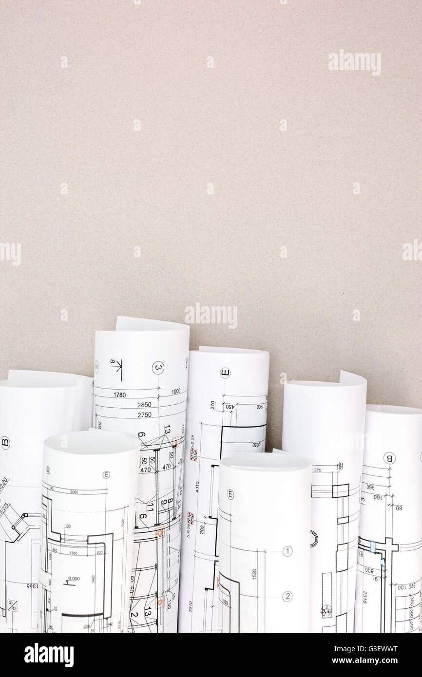architectural background with rolls of technical drawings top view ...