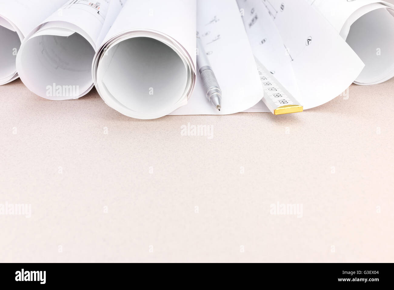 rolls of architecture blueprints and plans with pencil and folding rule ...