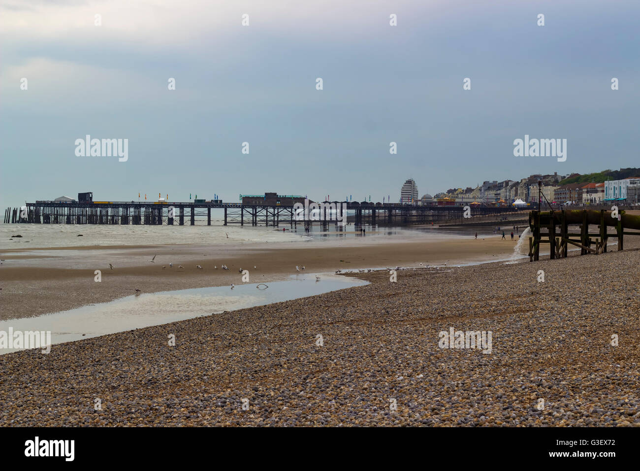View of the pebble beach of Hastings facing the sea with the pier in ...
