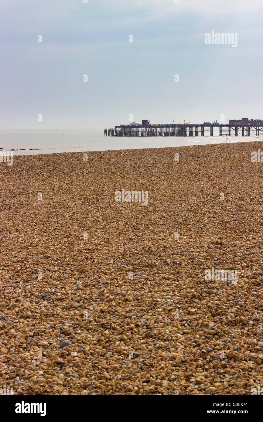 View of the pebble beach of Hastings facing the sea with the pier in ...