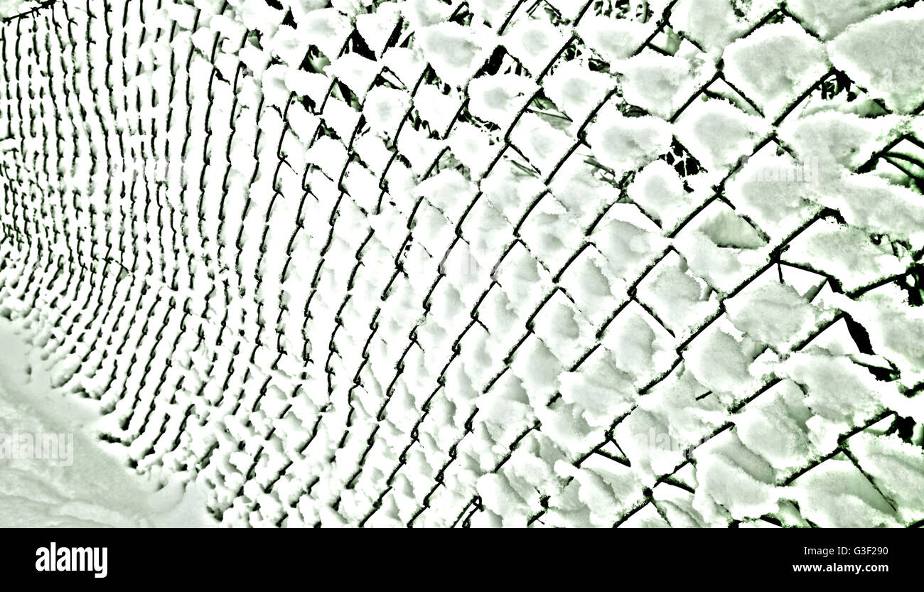 Chain-link fence with snow Stock Photo - Alamy
