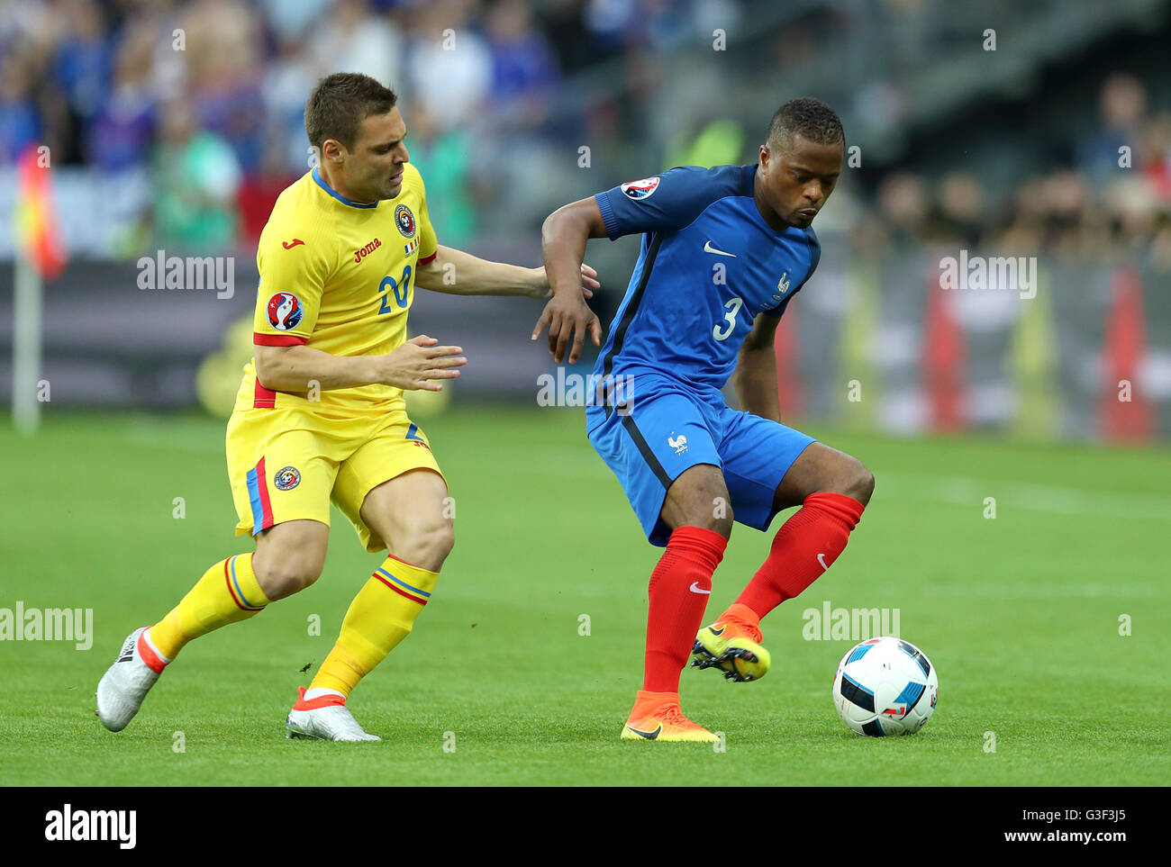 Romania's Adrian Popa (left) and France's Patrice Evra battle for the ...