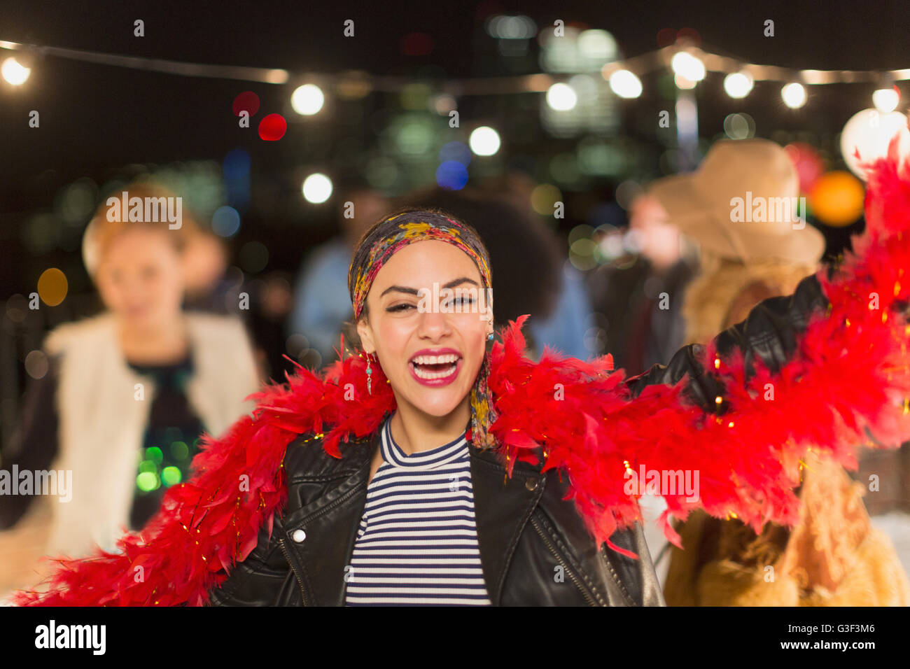 Portrait enthusiastic young woman dancing at rooftop party Stock Photo ...