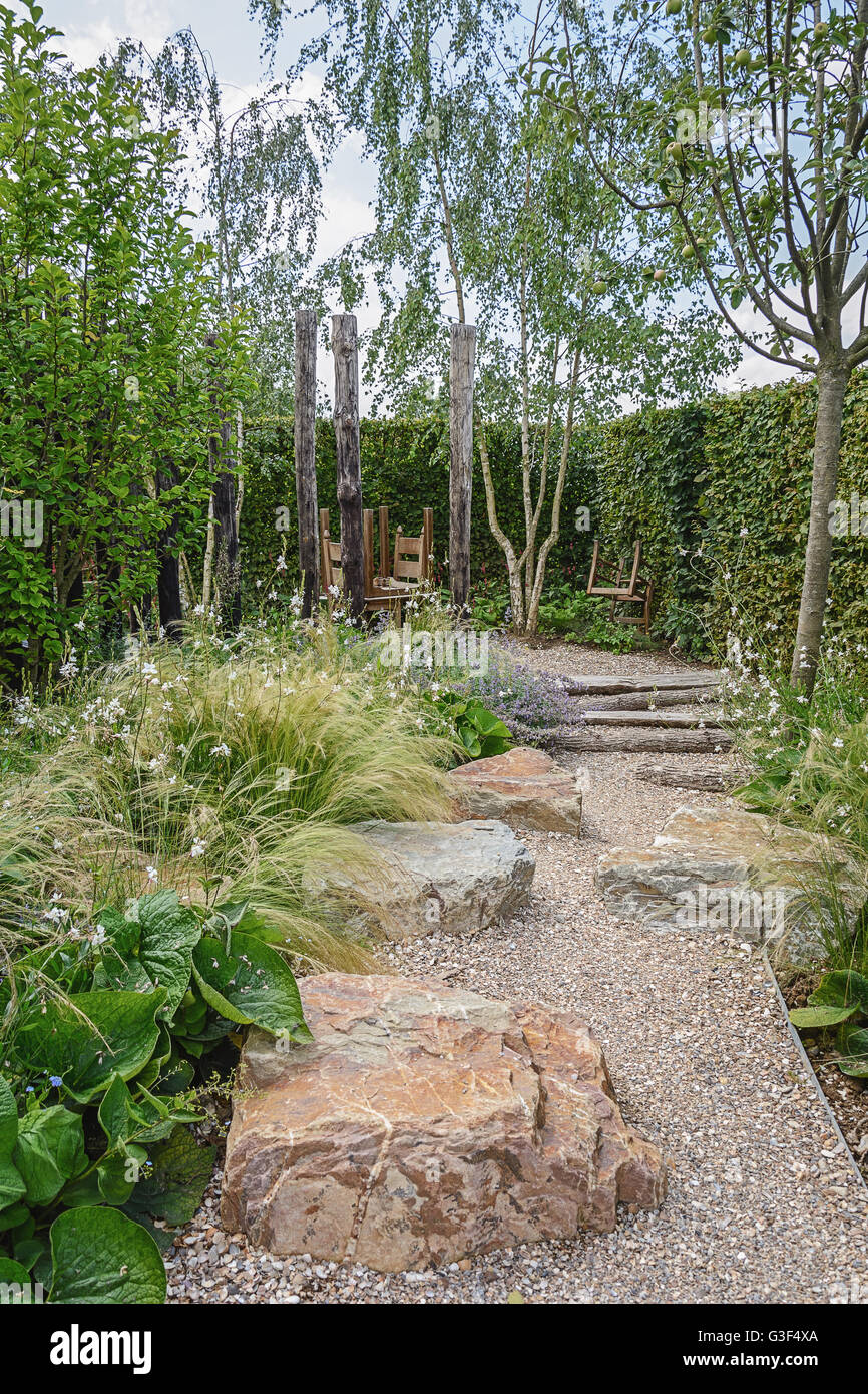The path covered with pebbles on the edges of large decorative stones ...