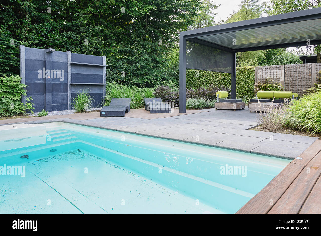 Swimmingpool with outdoors shower, trendy sunloungers and overhang with ...