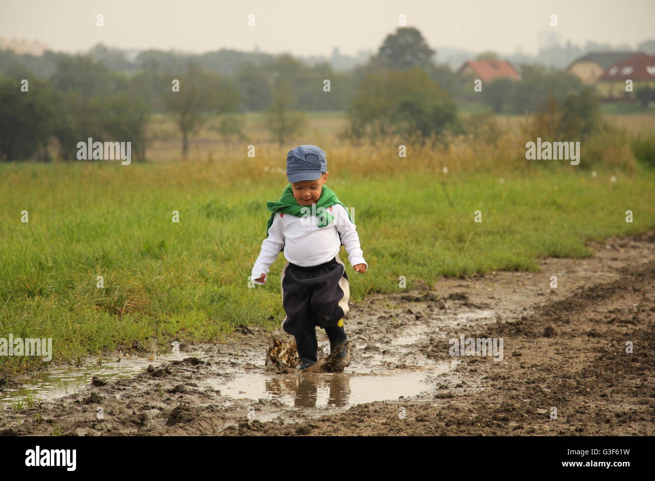 Child running in a puddle hi-res stock photography and images - Alamy