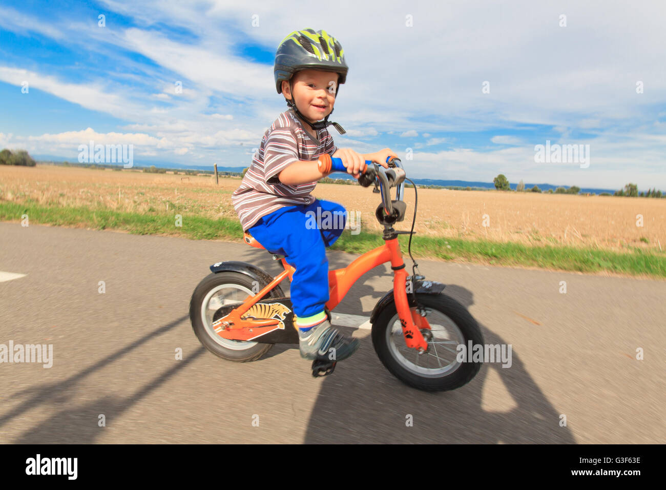 Little boy on a bicycle for the first time Stock Photo - Alamy
