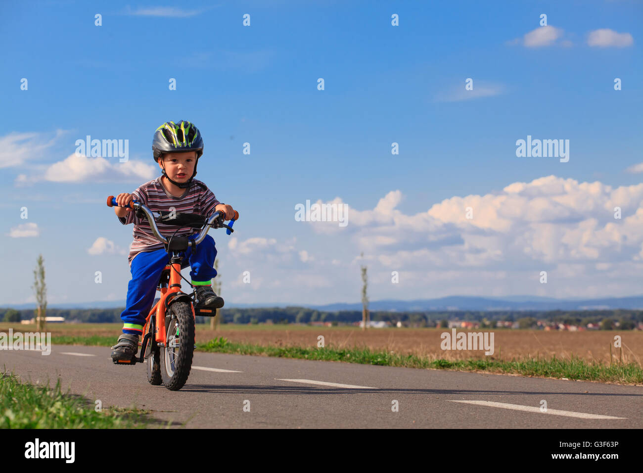 Little boy on a bicycle for the first time Stock Photo - Alamy