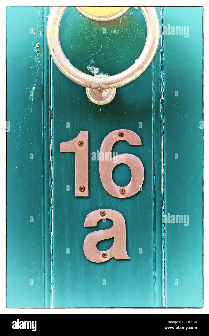 Light blue English period wooden front door with ornate iron door ...
