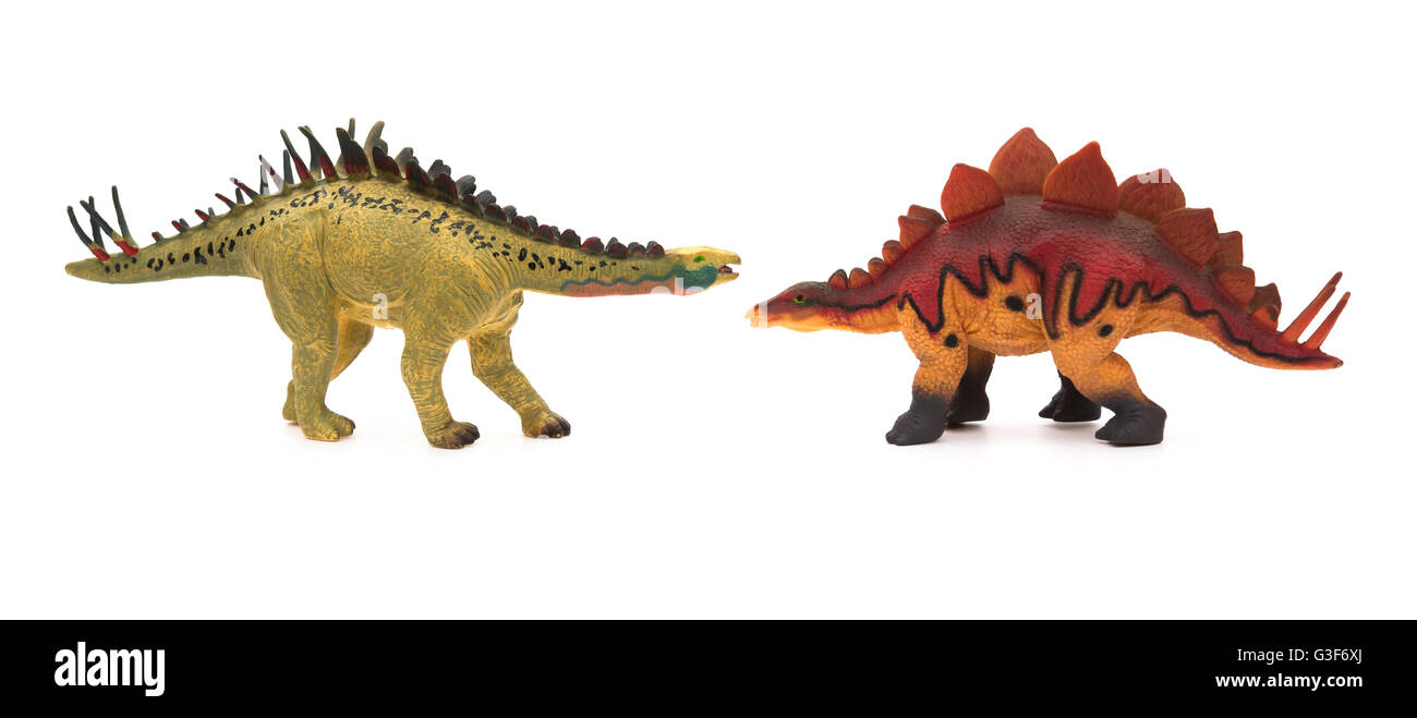 yellow huayangosaurus and red stegosaurus toys on a white background ...