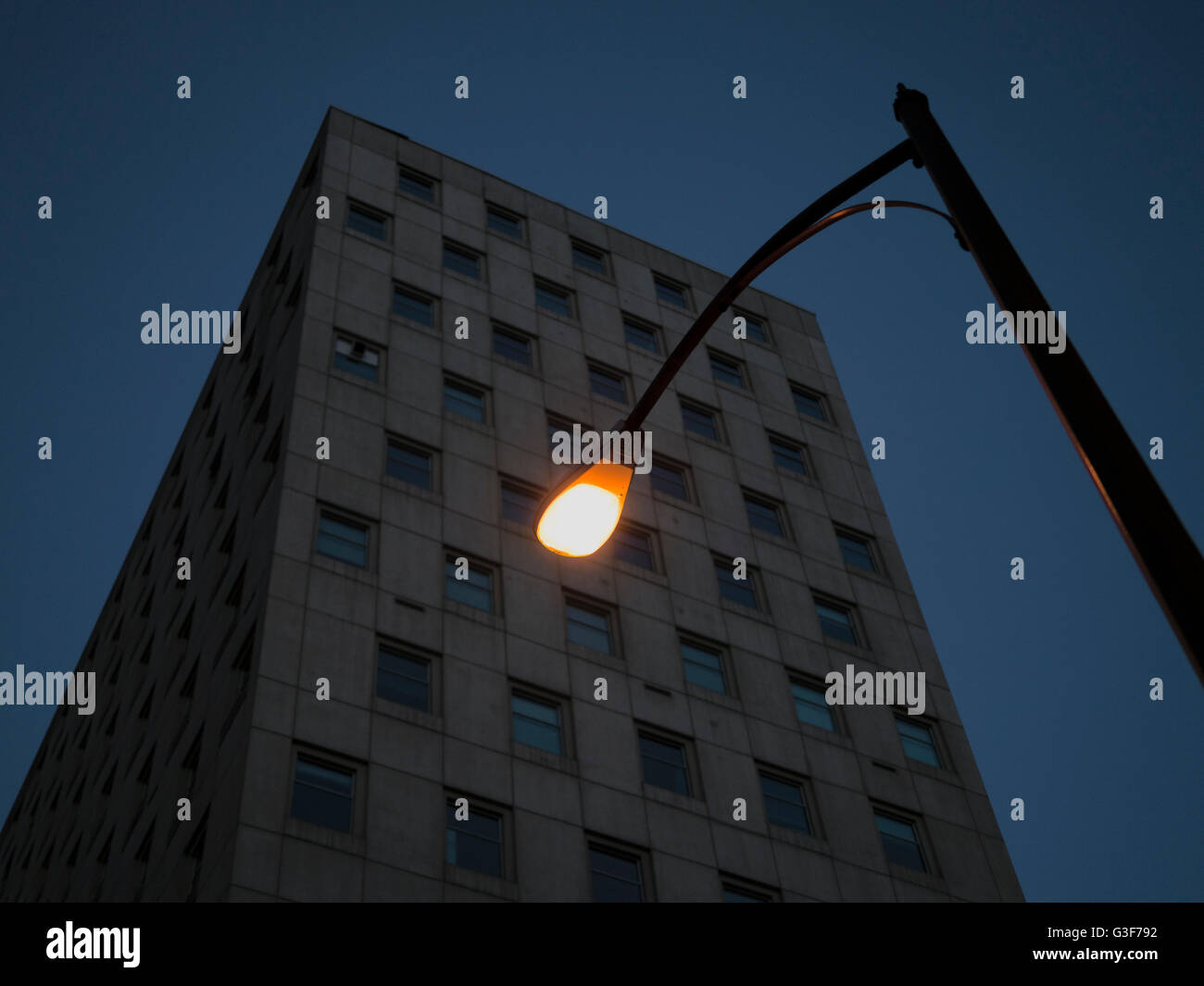 single street light dark high rise office building no lights on night ...