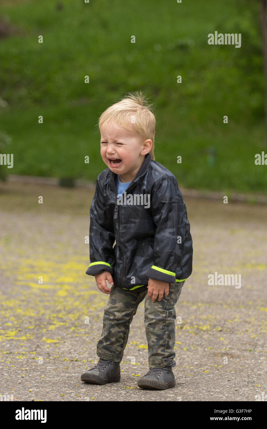 Blond kid crying very loud on the street Stock Photo - Alamy