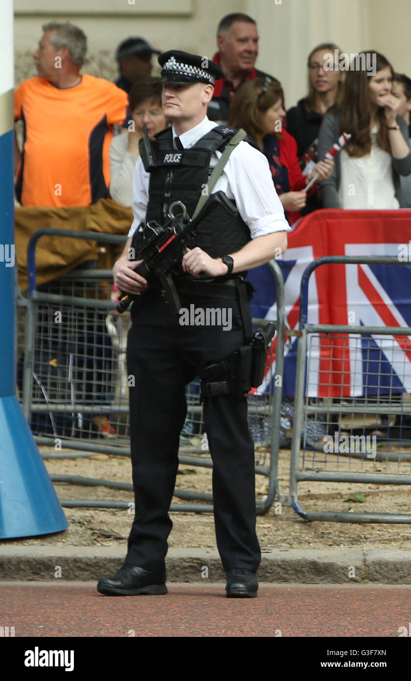 Armed police on patrol before the royal procession make its way down ...