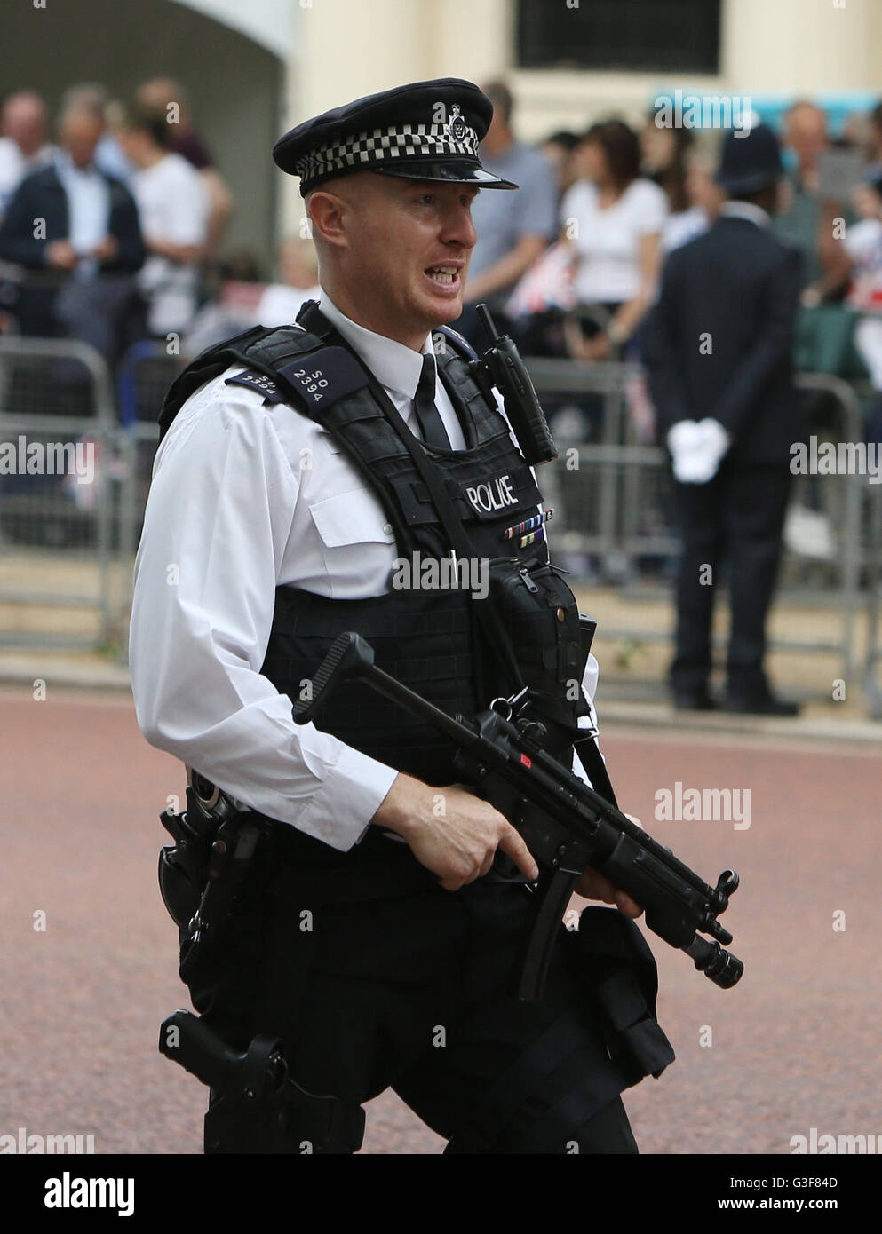 Armed police on patrol before the royal procession make its way down ...