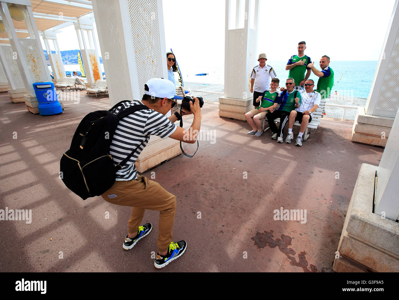Northern Irish football fans are photographed by passers by as they ...