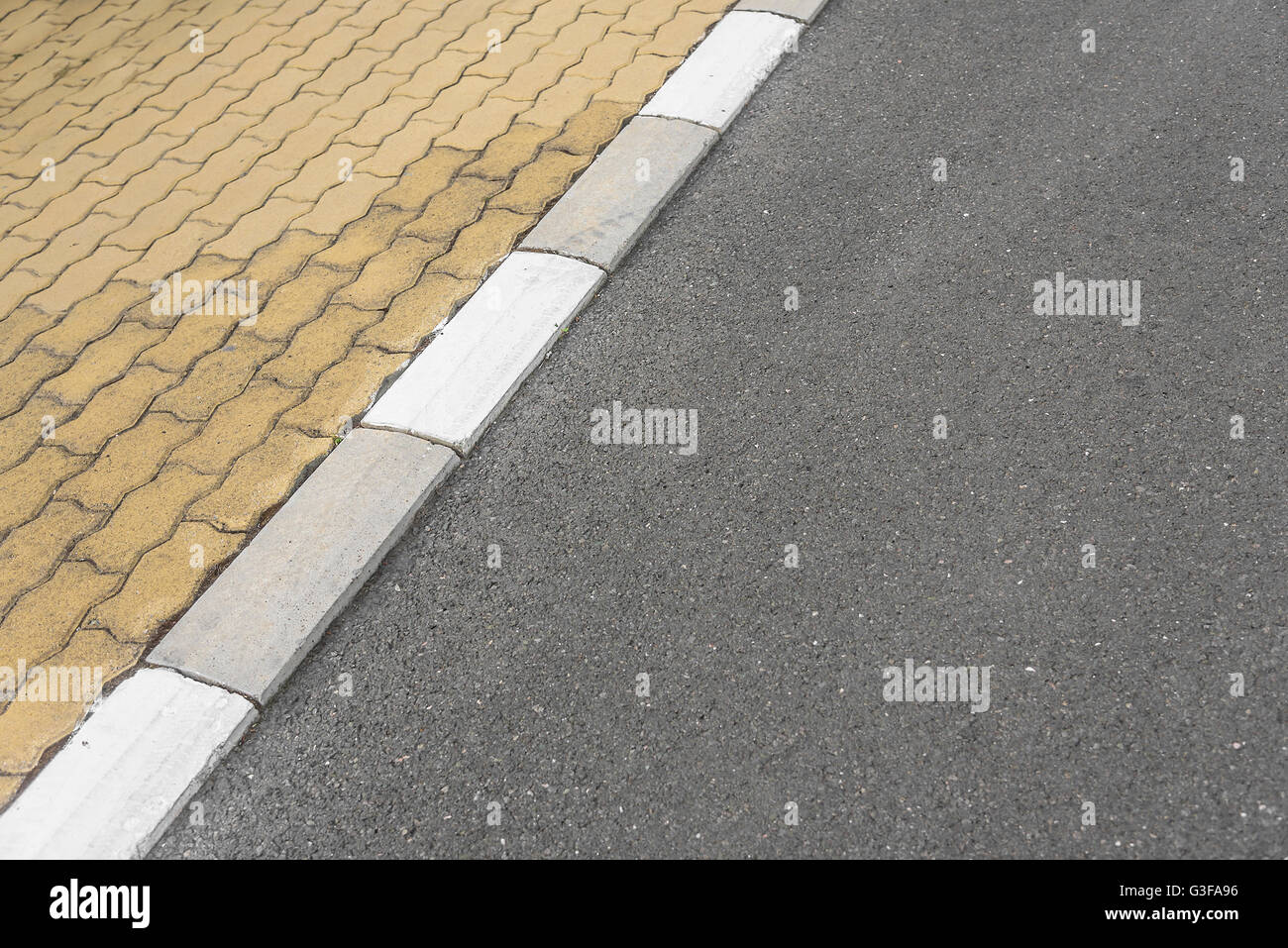 Striped border between the sidewalk and the asphalt road Stock Photo ...