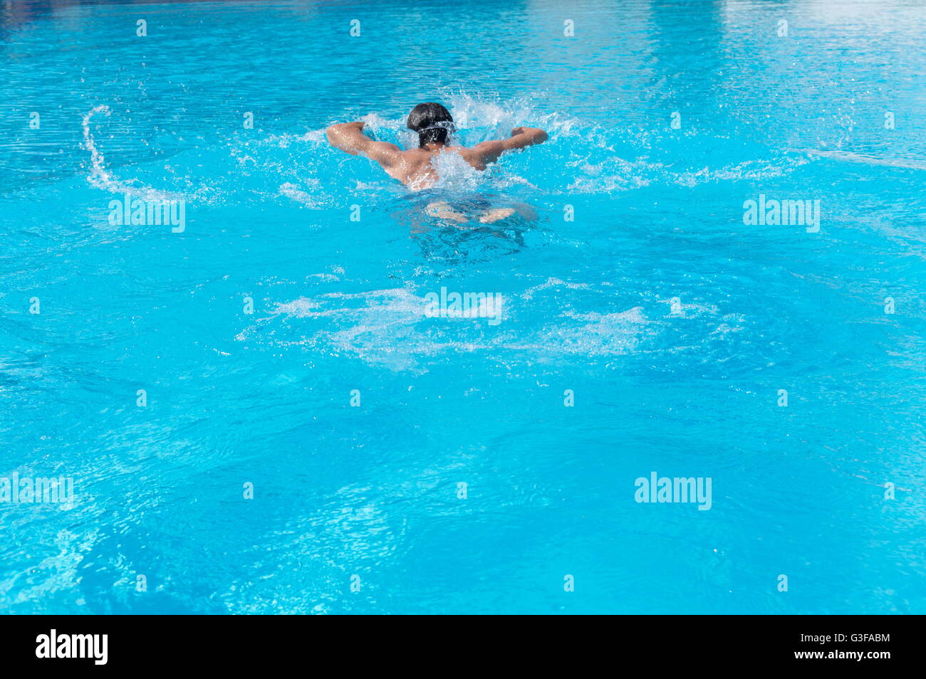 Man swimming in the swimming pool alone. Summer vacation Stock Photo ...