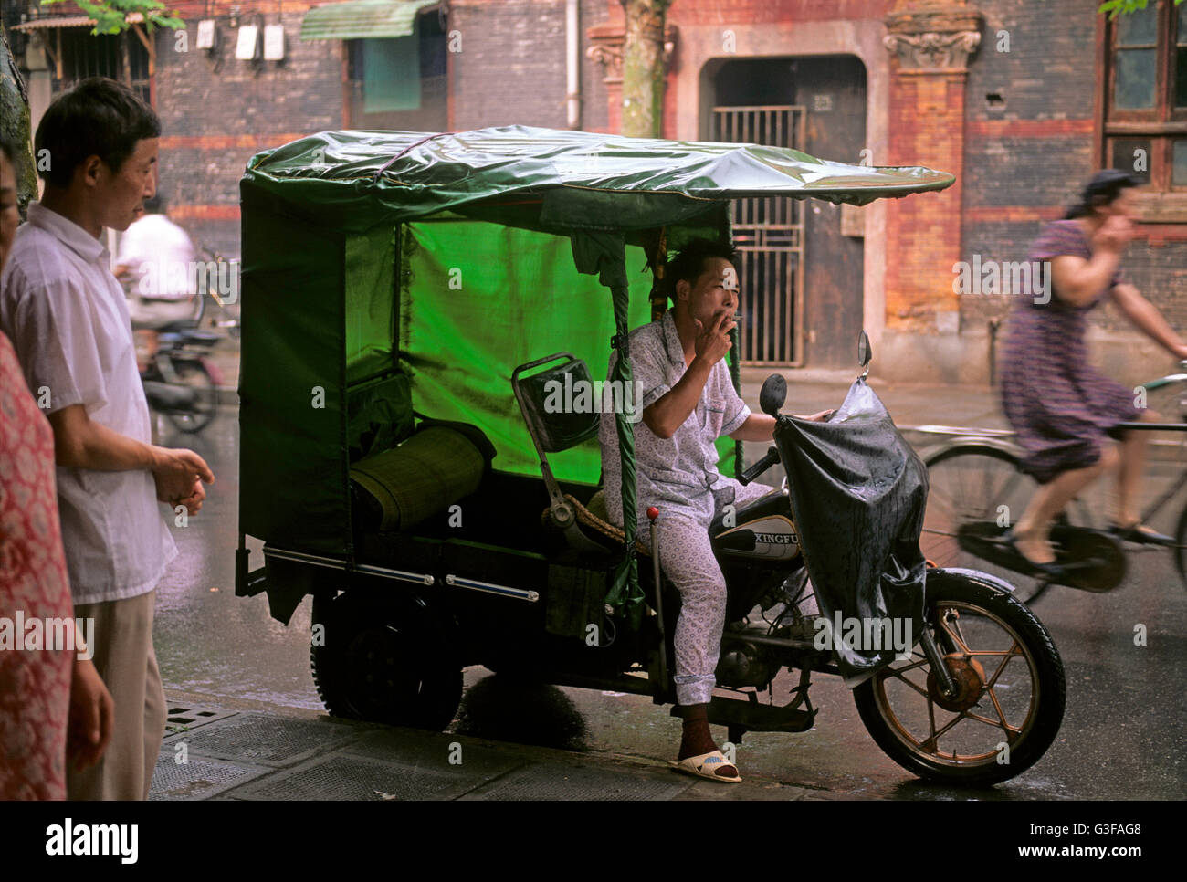 Motor rickshaw and his driver, Shanghai, China Stock Photo - Alamy