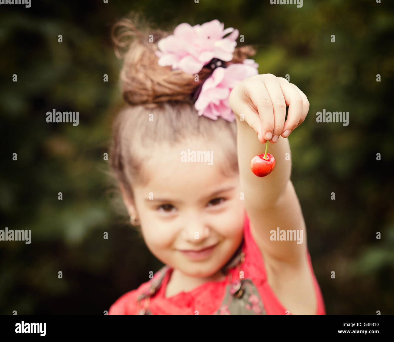 Child holding cherry Stock Photo - Alamy