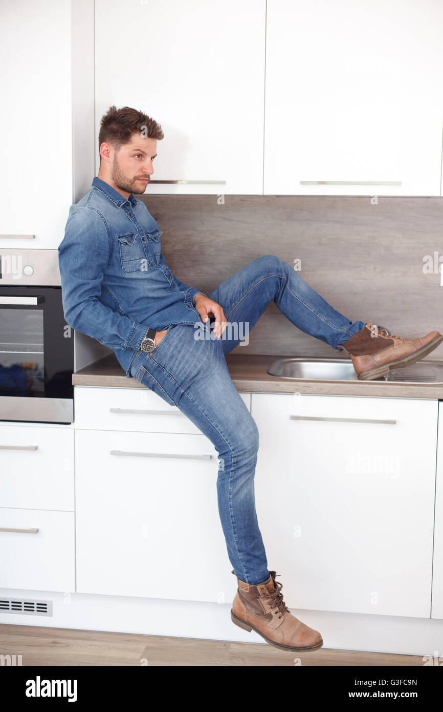 Man sitting at kitchen counter hi-res stock photography and images - Alamy