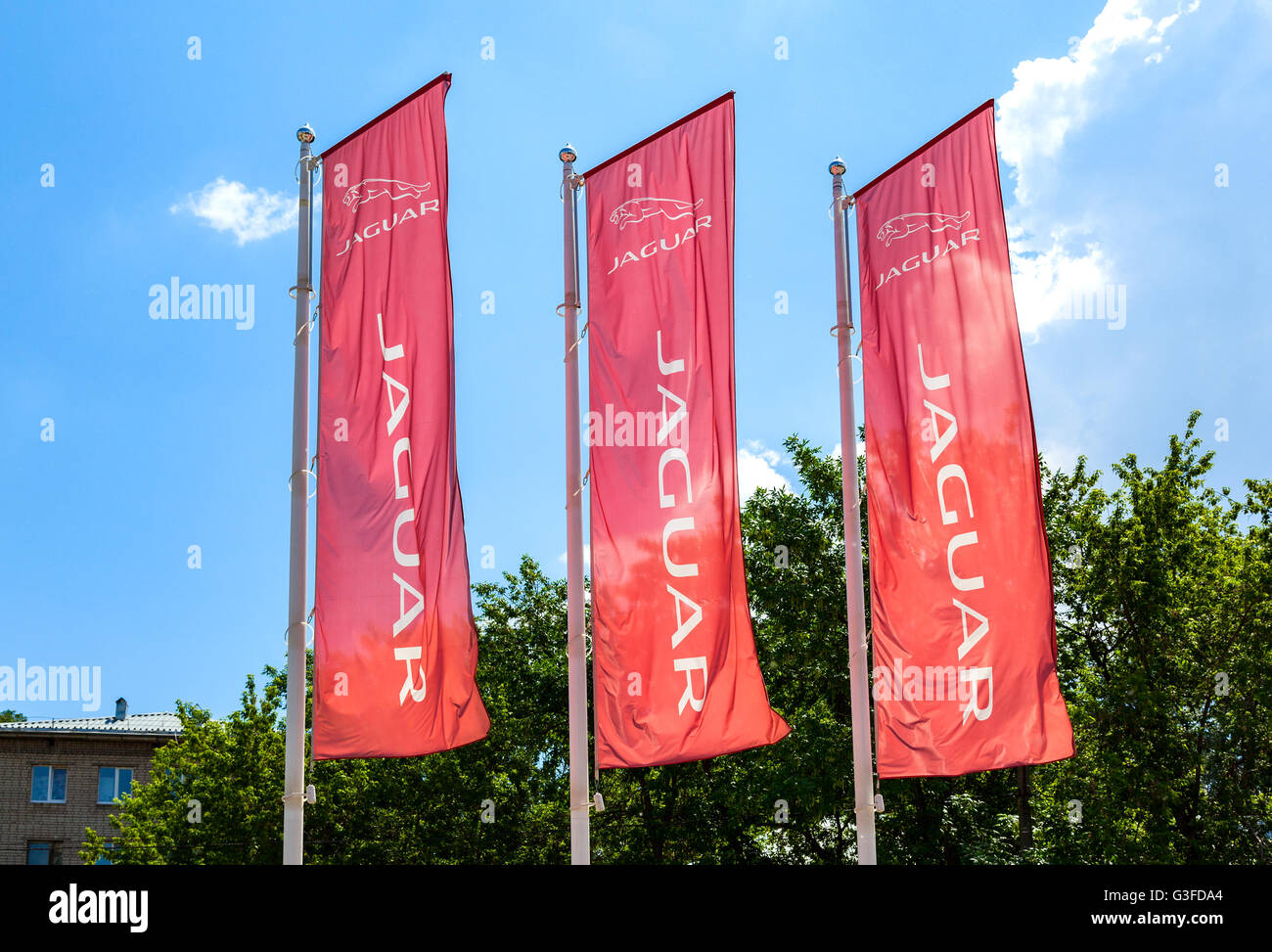 Official dealership flags of Jaguar against the blue sky background ...