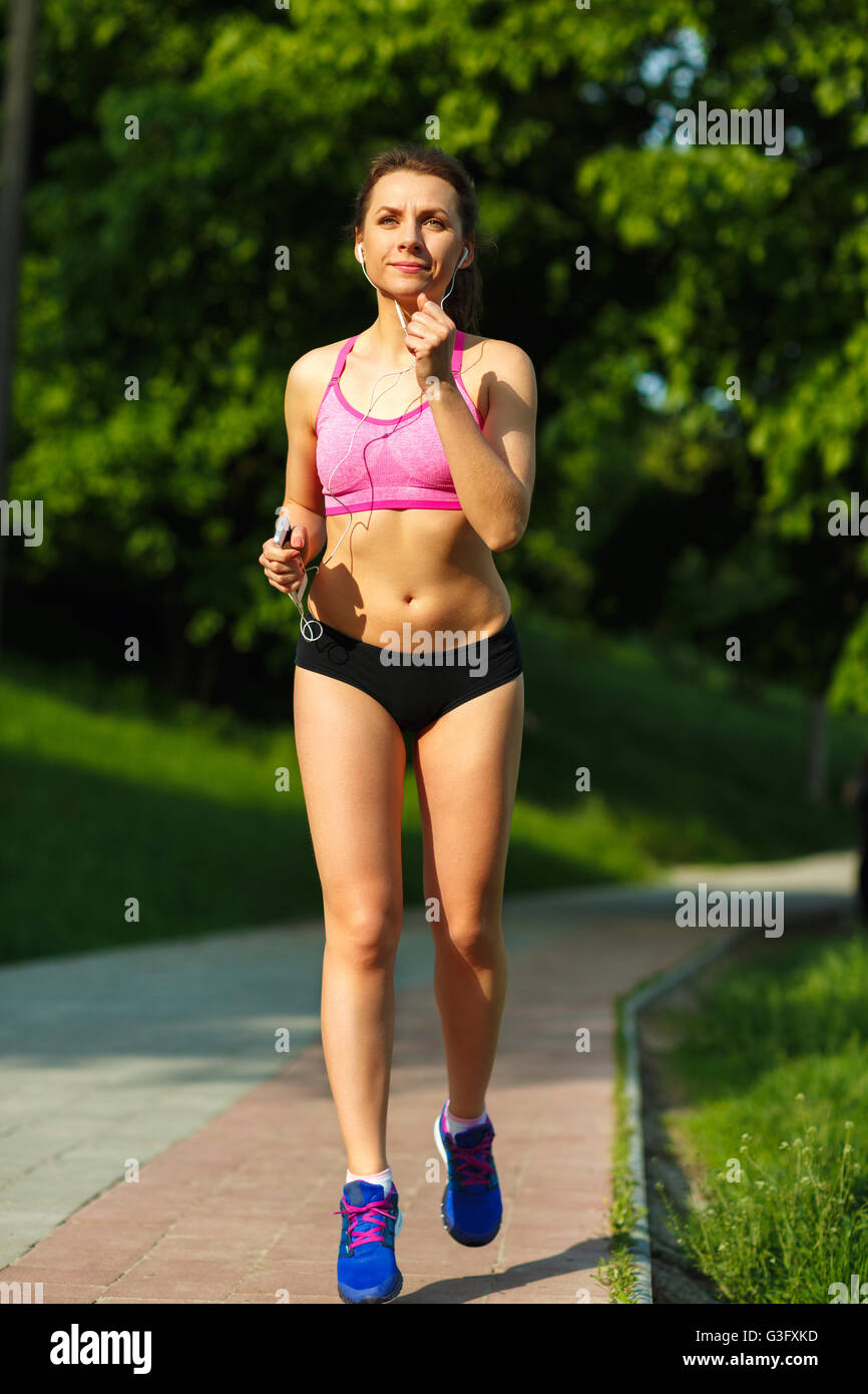 Young fitness woman runner running on trail in the morning Stock Photo - Alamy