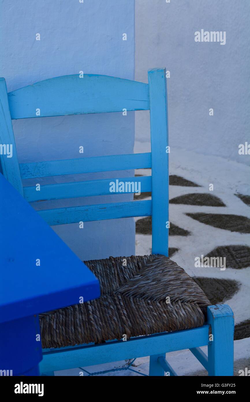 blue painted chairs and tables at a bar on the Greek island of Skopelos ...
