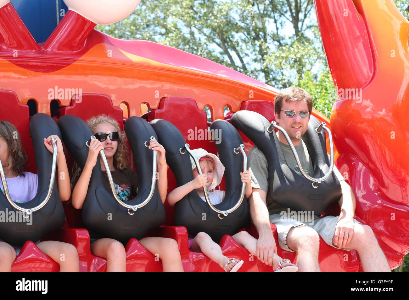 People sitting on a Ride at an Amusement Park Stock Photo - Alamy