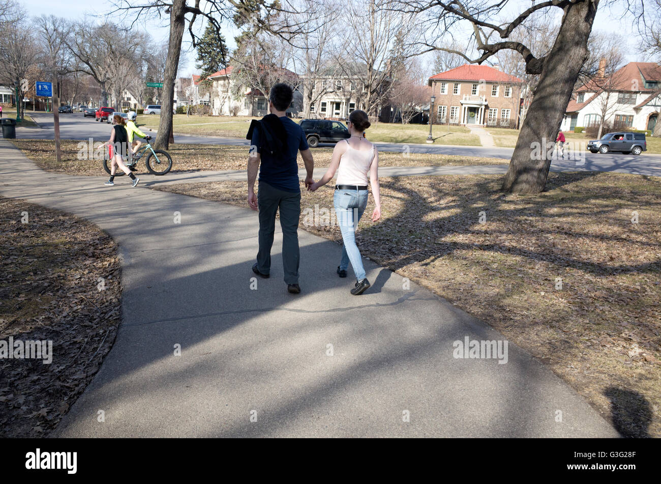 Romantic couple walking hand in hand on a pedestrian path along North ...