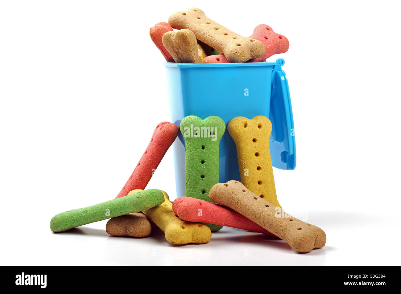 coloured pet treats inside and outside a blue rubbish bin on a white ...