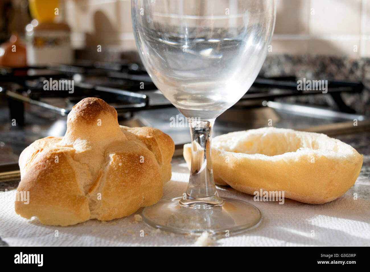 bread roll half cut with a beer glass on a stove-top Stock Photo - Alamy