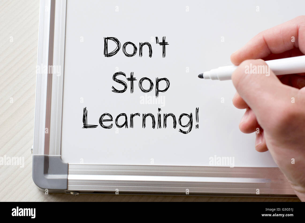 Human hand writing don't stop learning on whiteboard Stock Photo - Alamy
