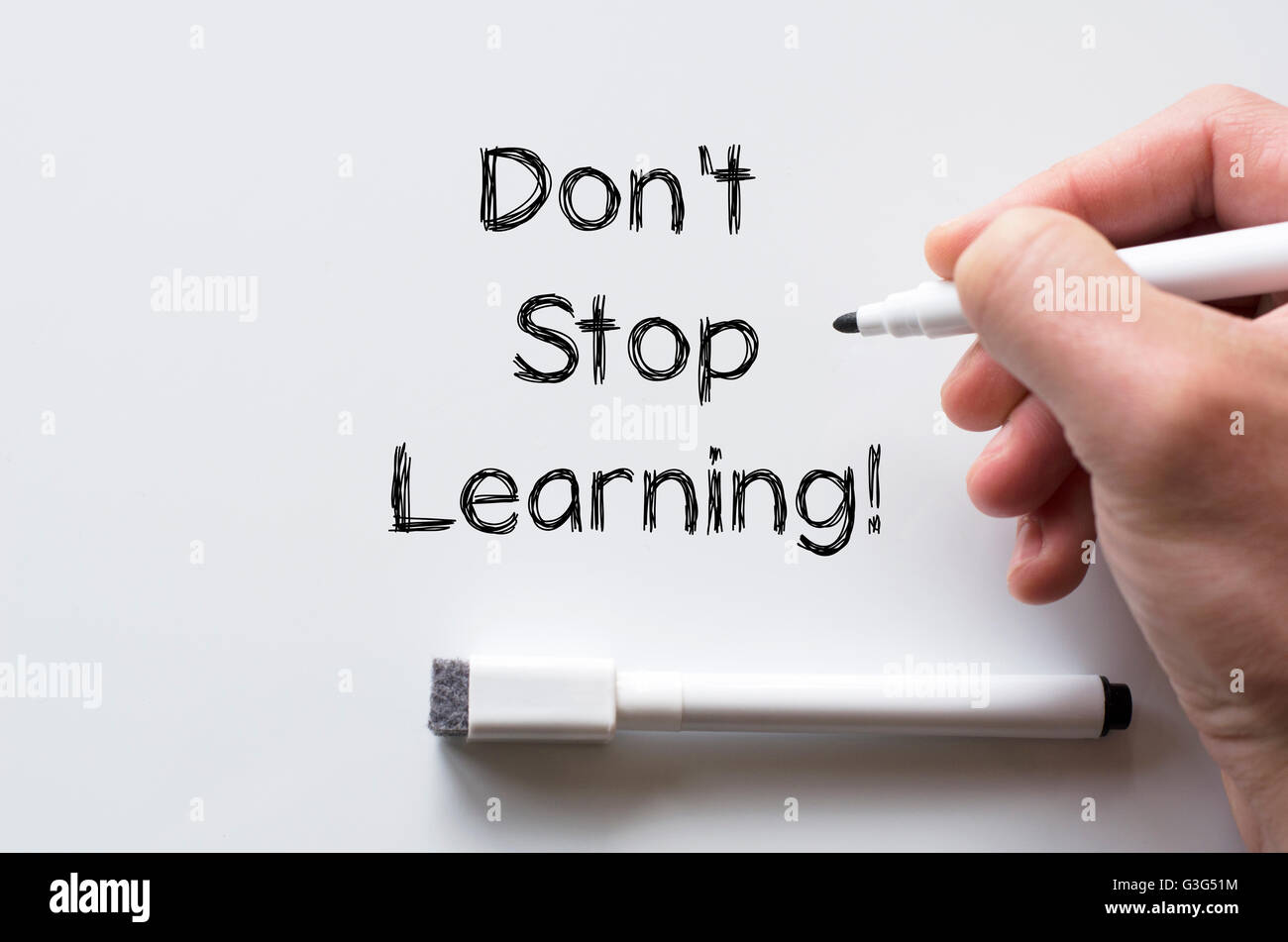 Human hand writing don't stop learning on whiteboard Stock Photo - Alamy