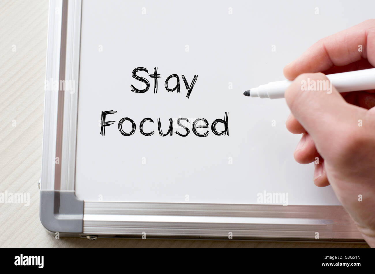 Human hand writing stay focused on whiteboard Stock Photo - Alamy